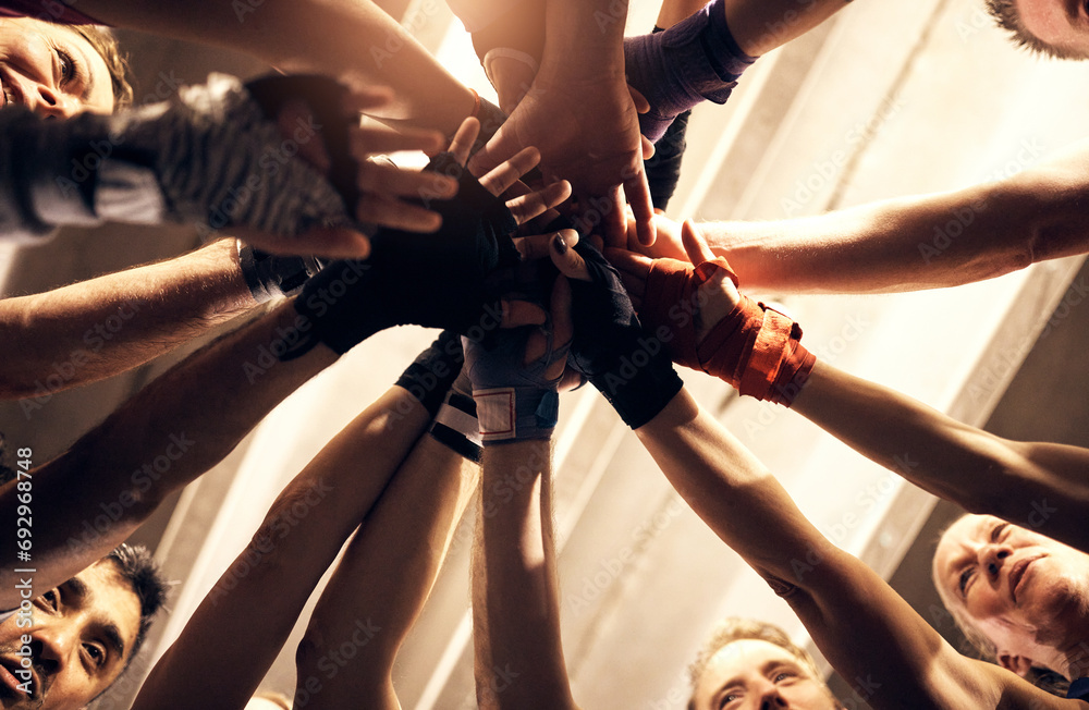 People smiling with their hands in a huddle in a boxing gym Stock Photo ...