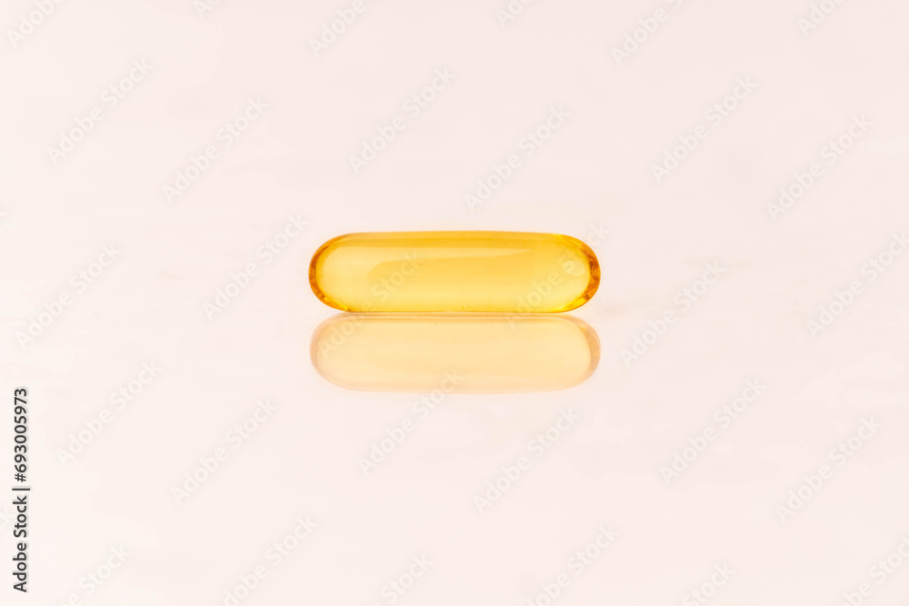 Close up of oil softgel capsules on white background with reflection ...
