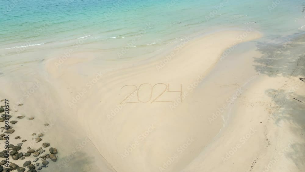2024 year written on a tropical beach. Concepts of entering the year ...