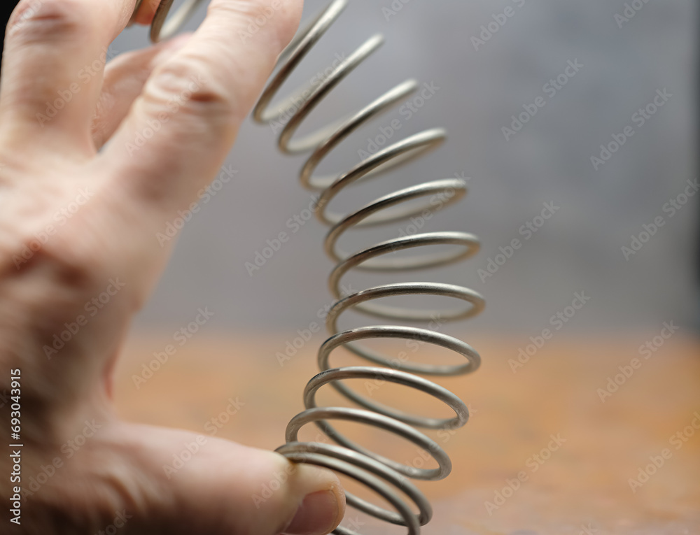 Springs is in the human hand. Metal background. Shallow depth of field ...