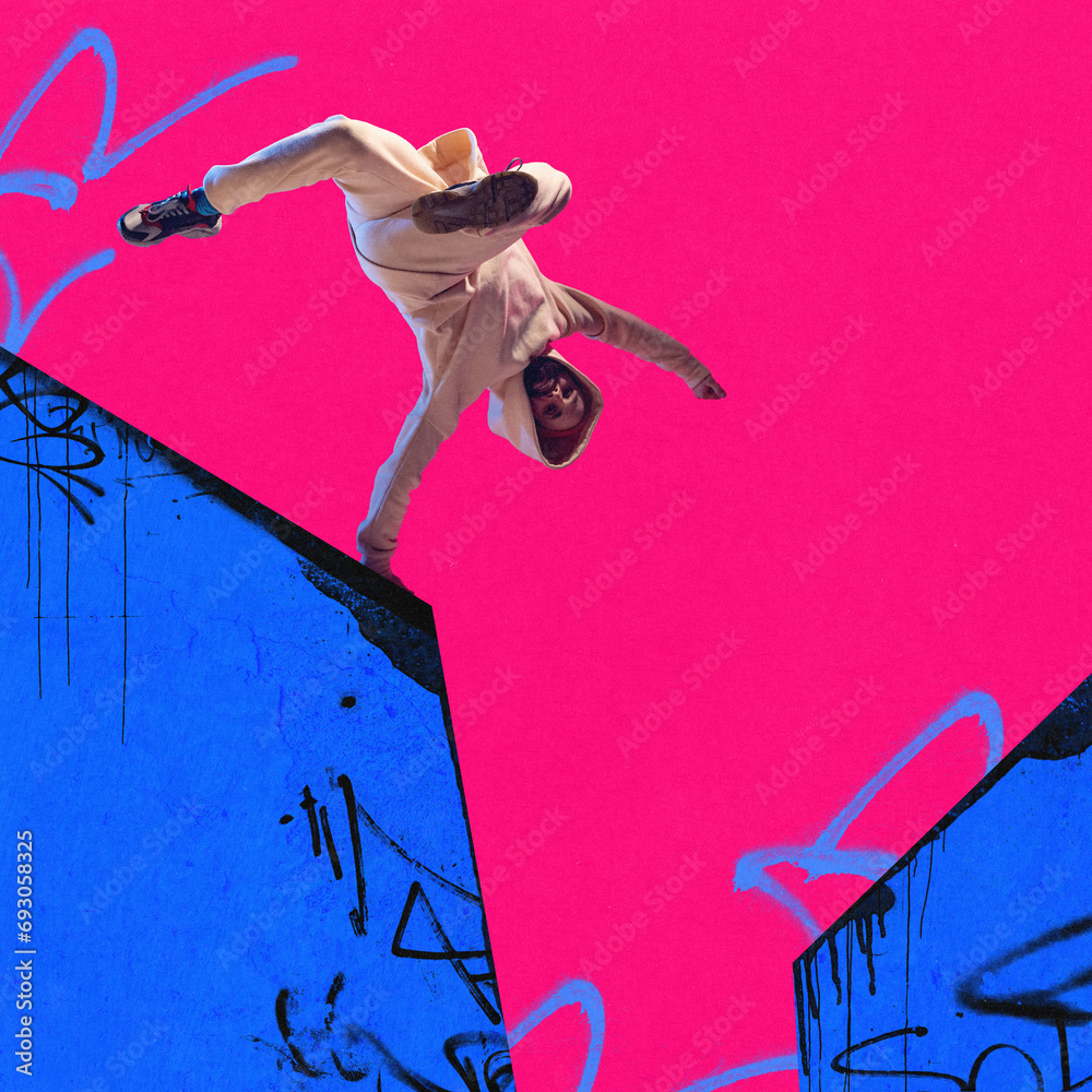 Extreme and dangerous activity. Young man doping parkour trick outdoors ...