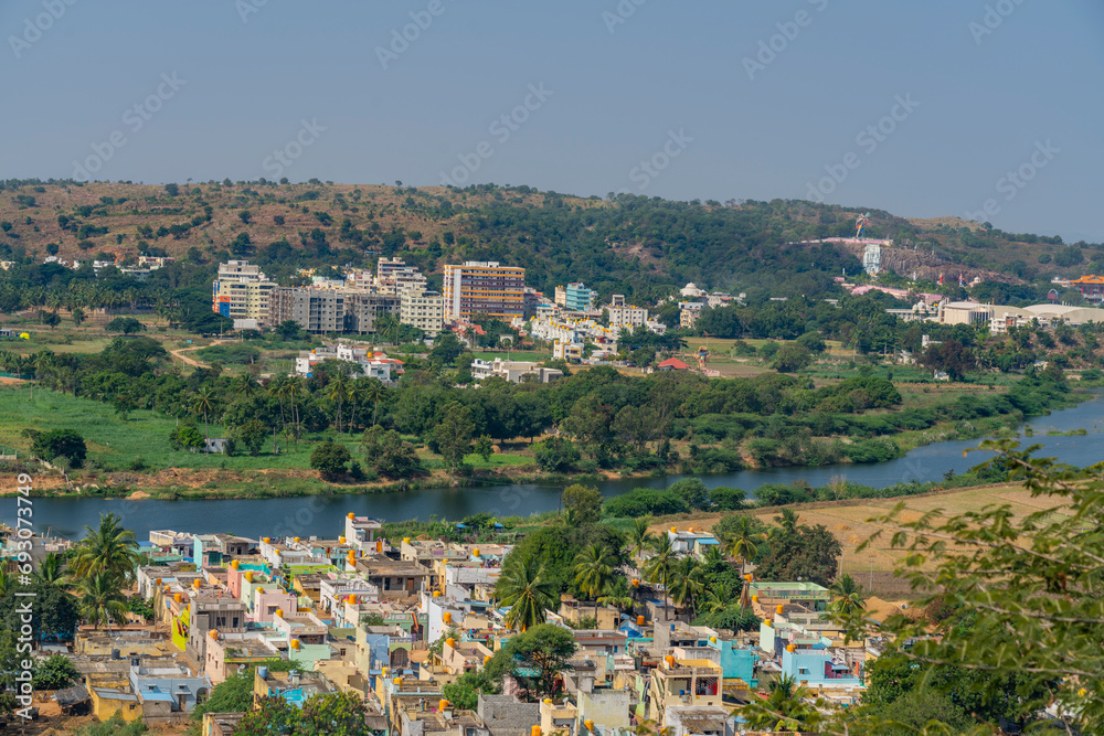 Landscape from Puttaparthi with the lake green trees,buildings, temple ...