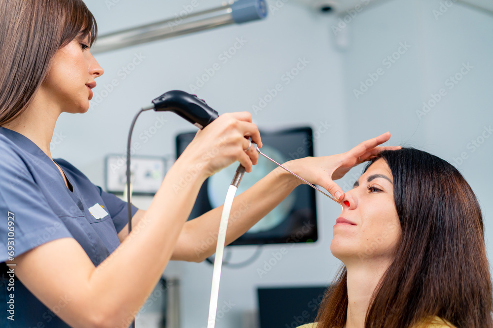 the ENT doctor performs the procedure of endoscopy of the patient's ...