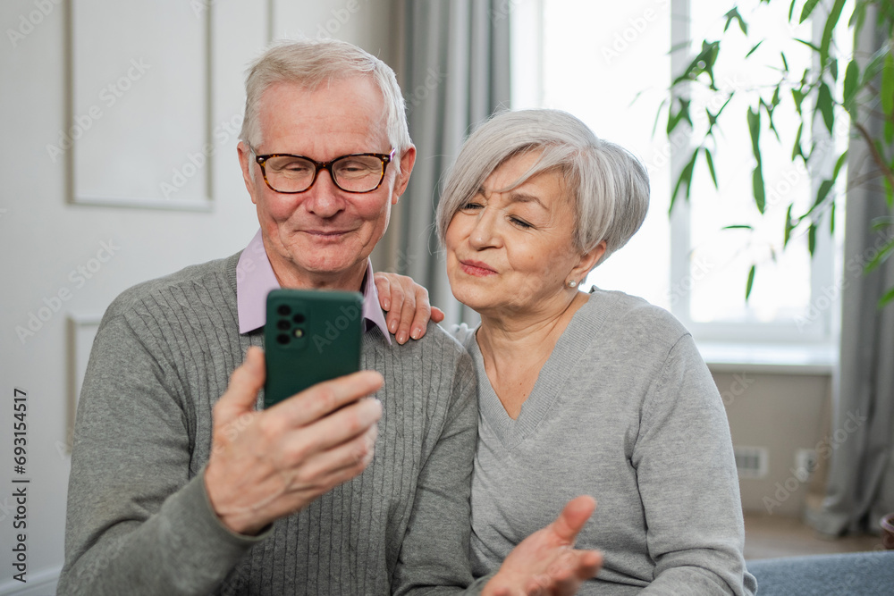 Video call. Happy senior couple woman man with smartphone having video ...