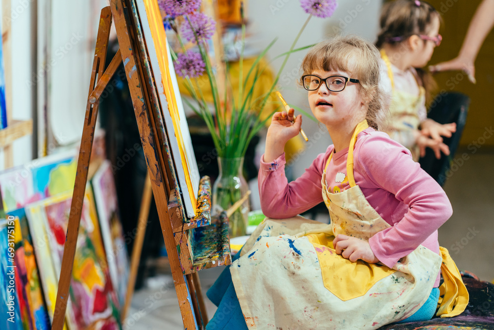Cute kid artist with down syndrome enjoys creative painting craft at ...