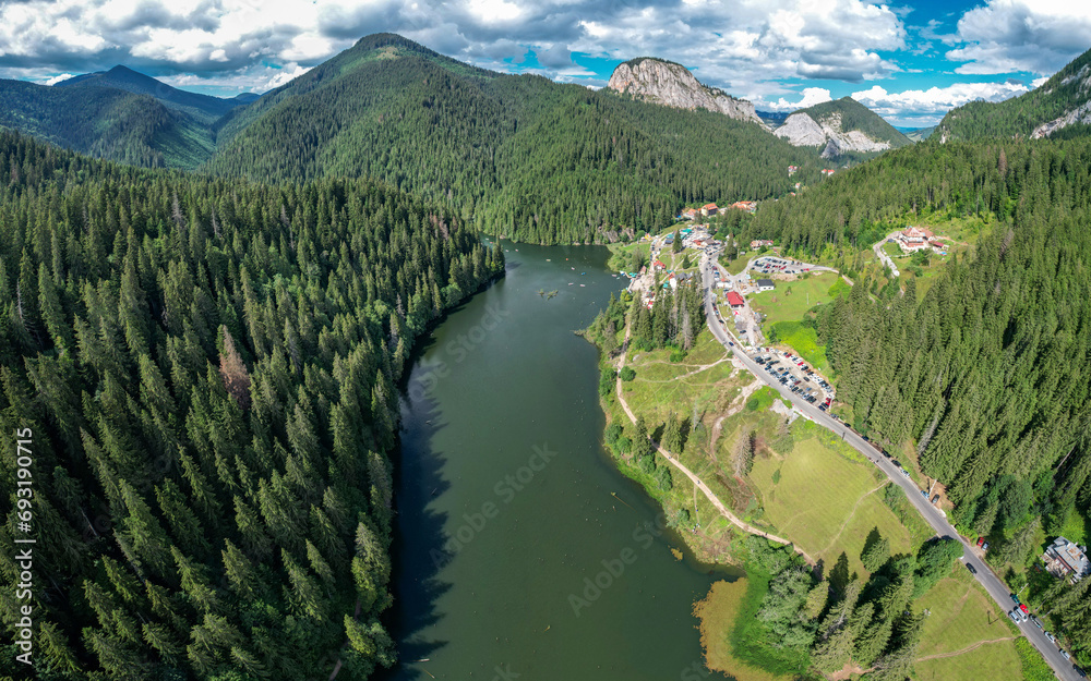 Aerial drone panorama of Red Lake and an asphalt road winding along its ...