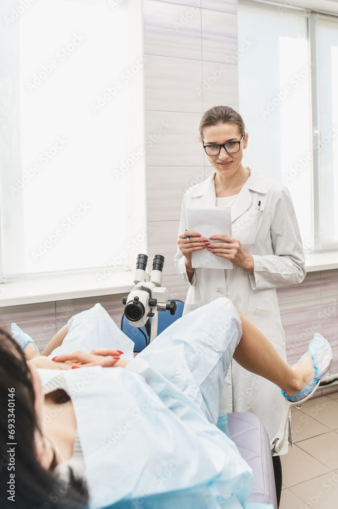 woman doctor look microscope at gynecologist's appointment. Female ...