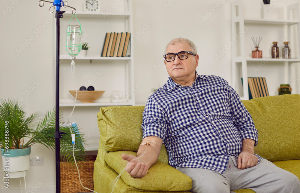 Senior male patient getting intravenous infusion. Retired, old, chubby ...