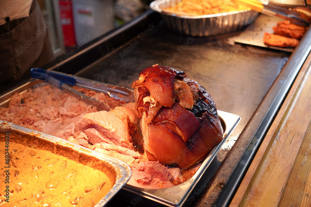 roast pork with crispy skin for sale at street vendor. Hog roast food ...