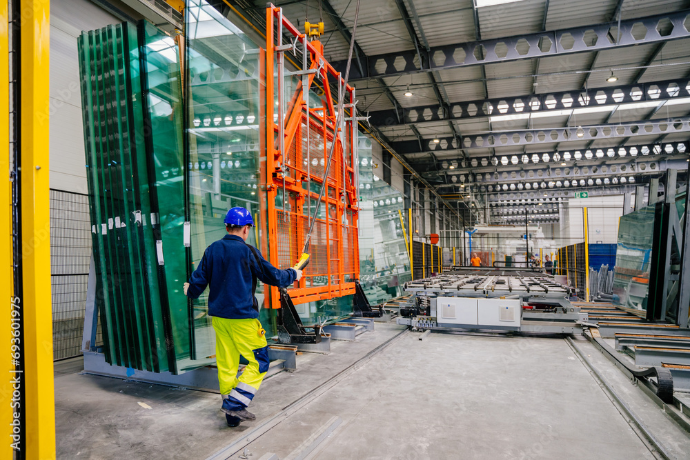 Modern interior of a large glass and mirror cutting factory. Modern ...