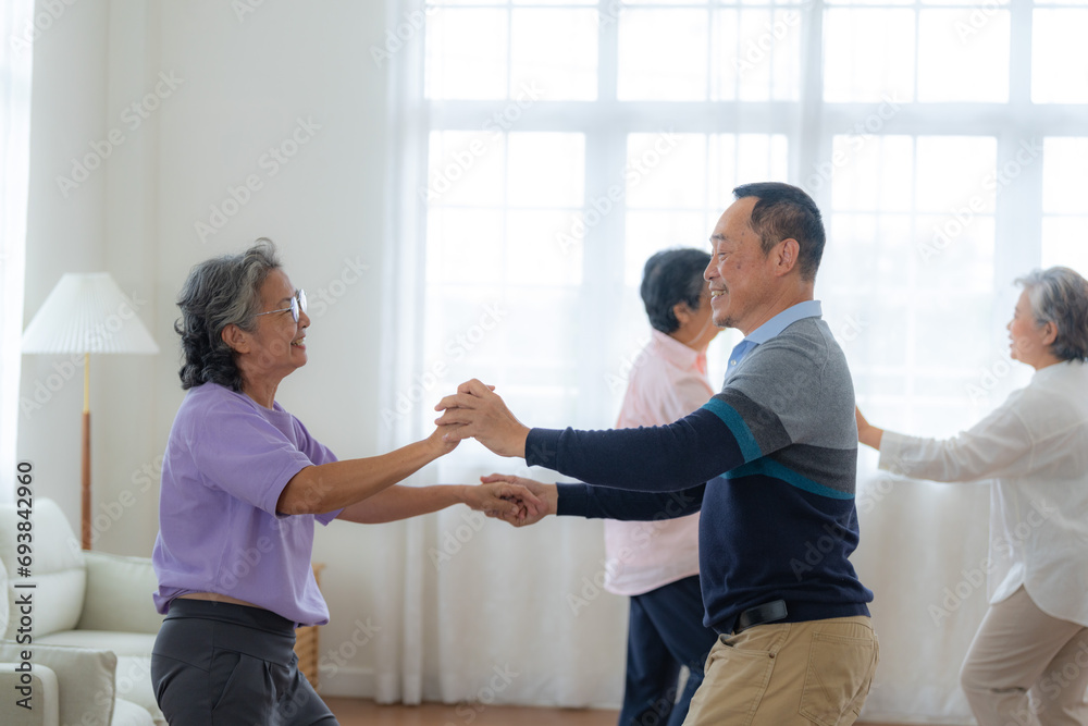Asian Older male and females people dance with their partners on a ...
