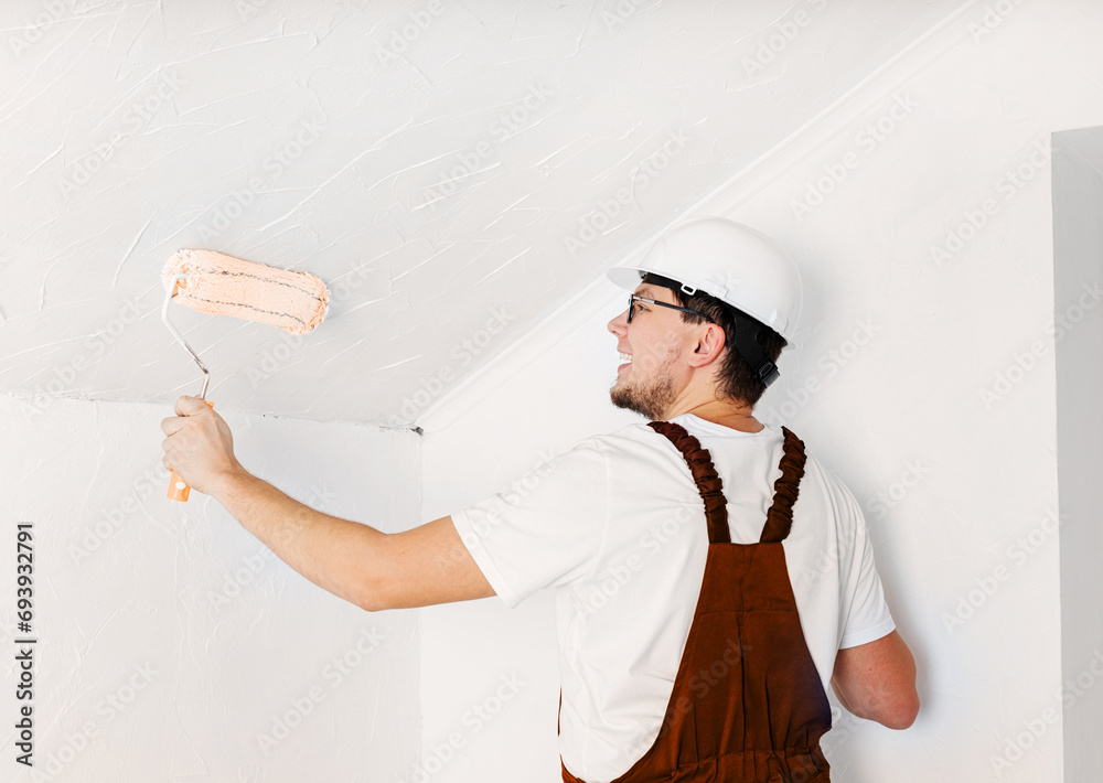 Color of the year 2024: Peach Fuzz. young man in overalls and hard hat ...
