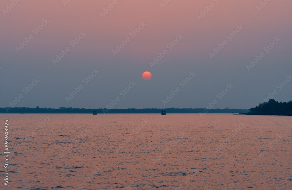 majestic scenic beauty of nature during sunset, on vast waterscape of ...