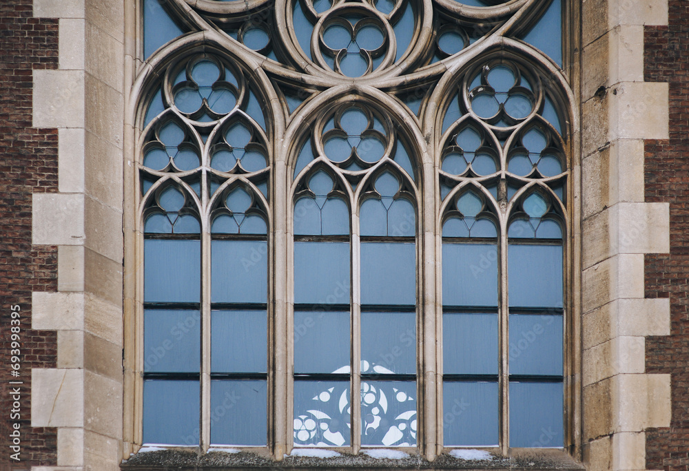 Pointed gothic windows with stained glass on facade of the building ...