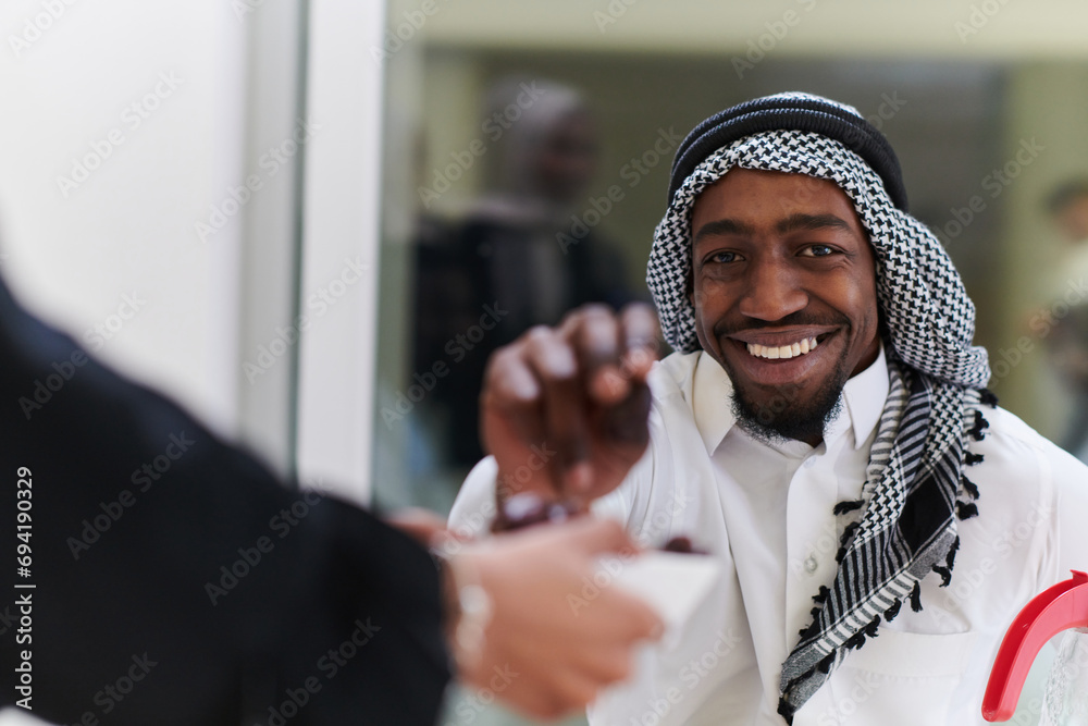 African American Muslim man delicately takes dates to break his fast ...