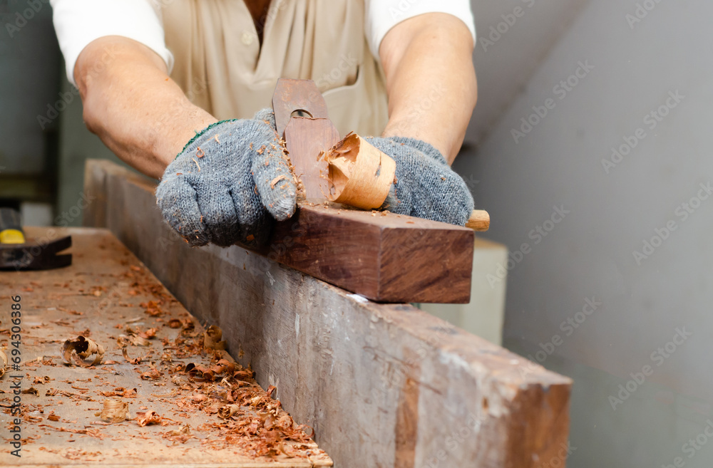 Carpenter's hands planing a plank of wood with a hand plane Stock Photo ...