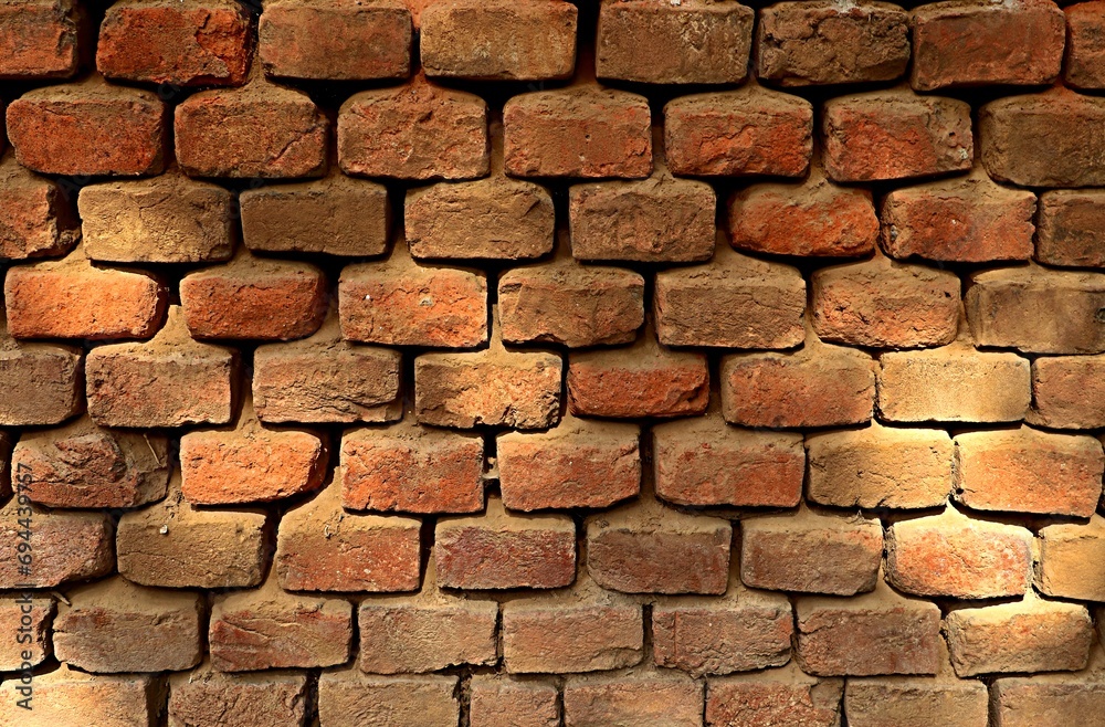 Background, texture, wall made of old brick with deep cracks between ...