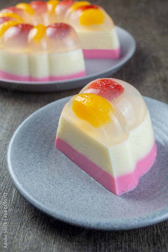 puding lapis or layer pudding with orange and strawberry slices served ...