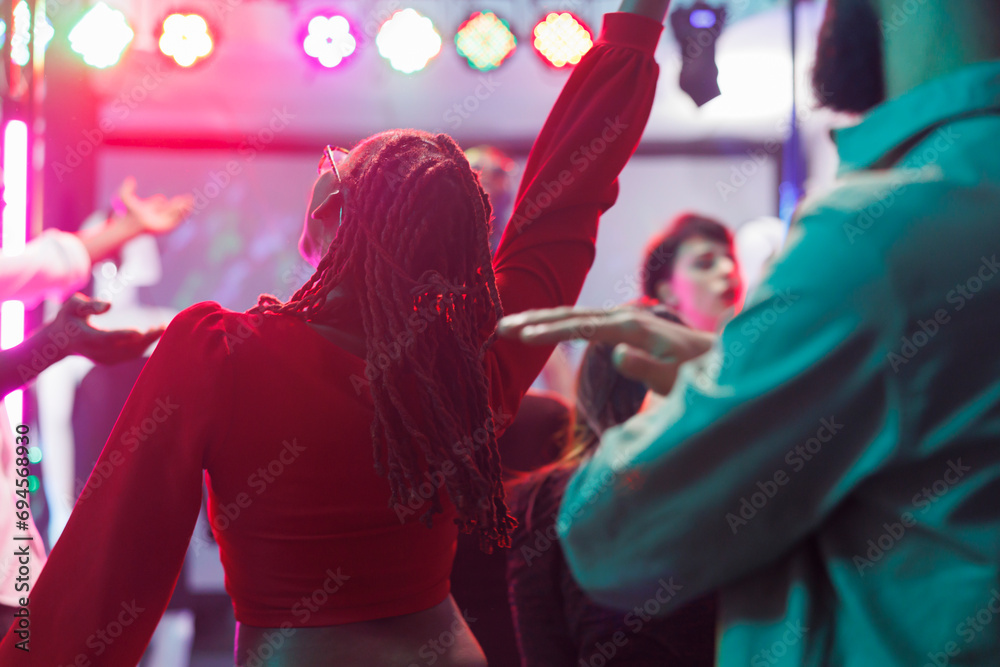African american woman in red blouse jumping and dancing in crowded ...