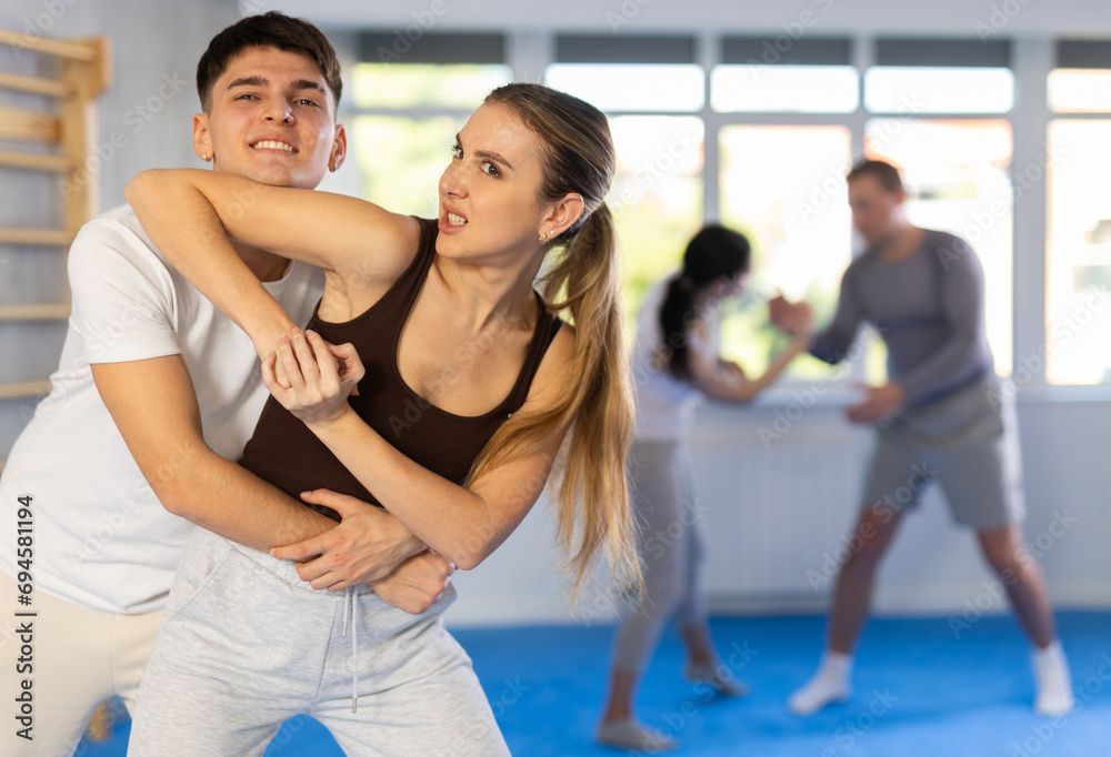Woman practices blows to the head of a male attacker during self ...