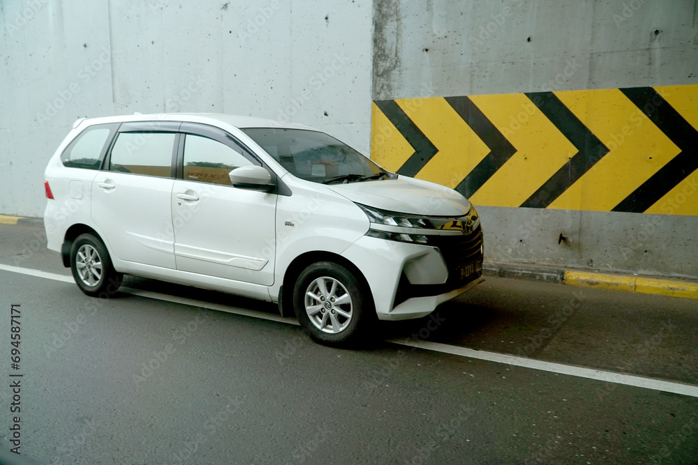 White Toyota Avanza Veloz entering underpass in highway Outer ring Road ...