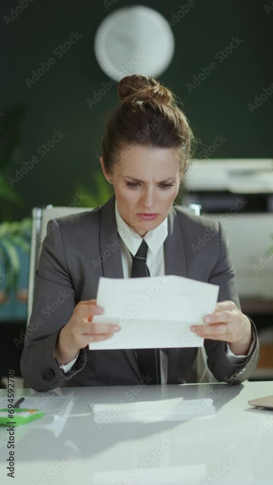 New job. sad modern middle aged woman worker in modern green office in ...