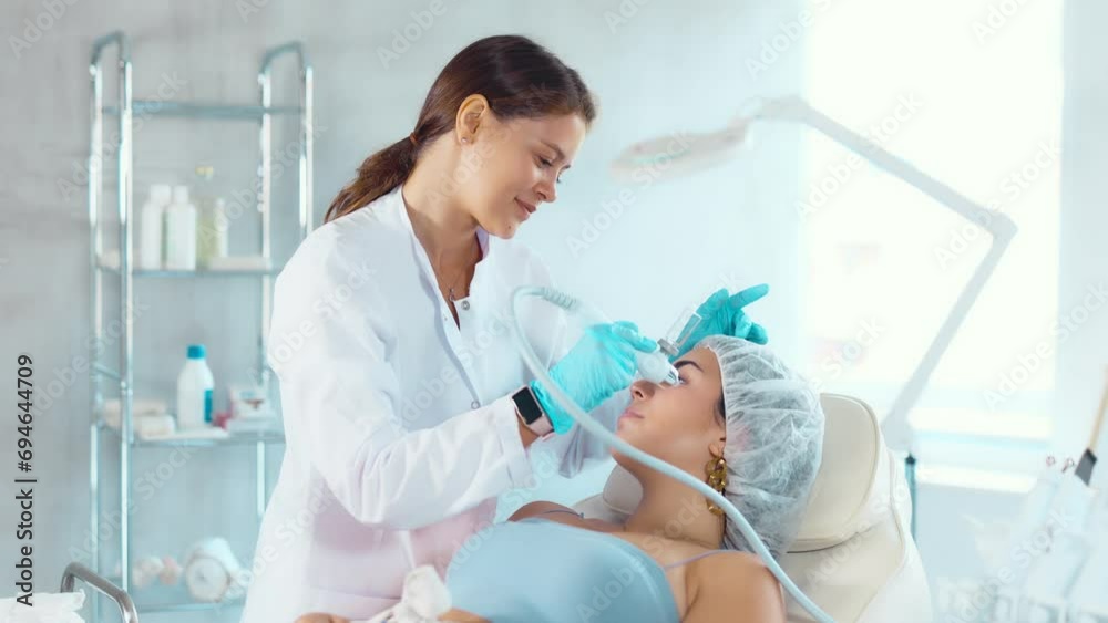 Focused young woman, professional cosmetologist performing hardware ...