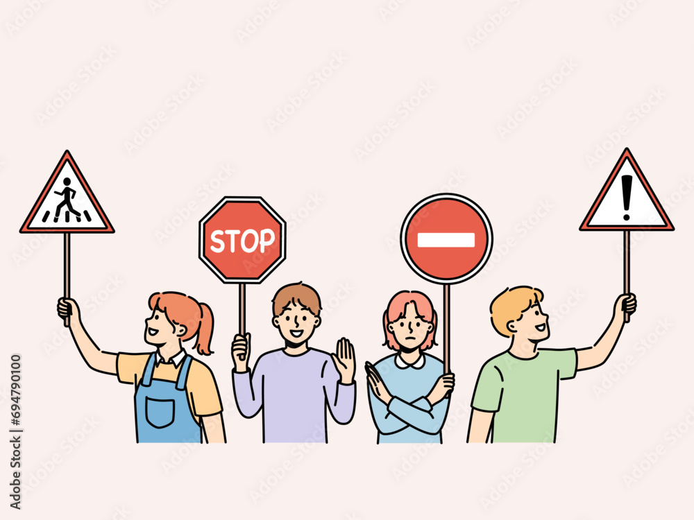 Young children hold traffic signs urging peers to follow safety rules ...