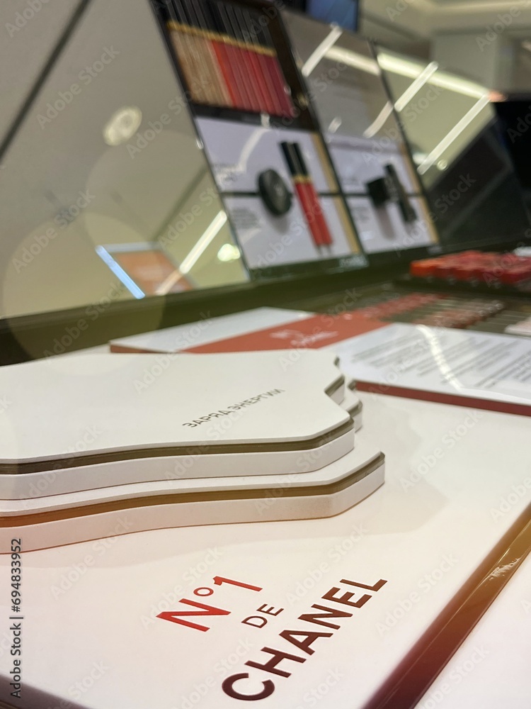 Products of famous French brand Chanel in official store. Counter in ...