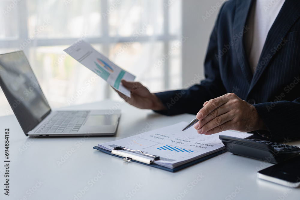 Accountant holding documents preparing performance analysis report ...