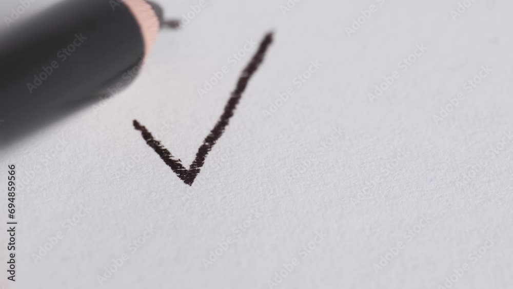 The woman wrote a check mark on the paper with a pencil. Hand draws a ...