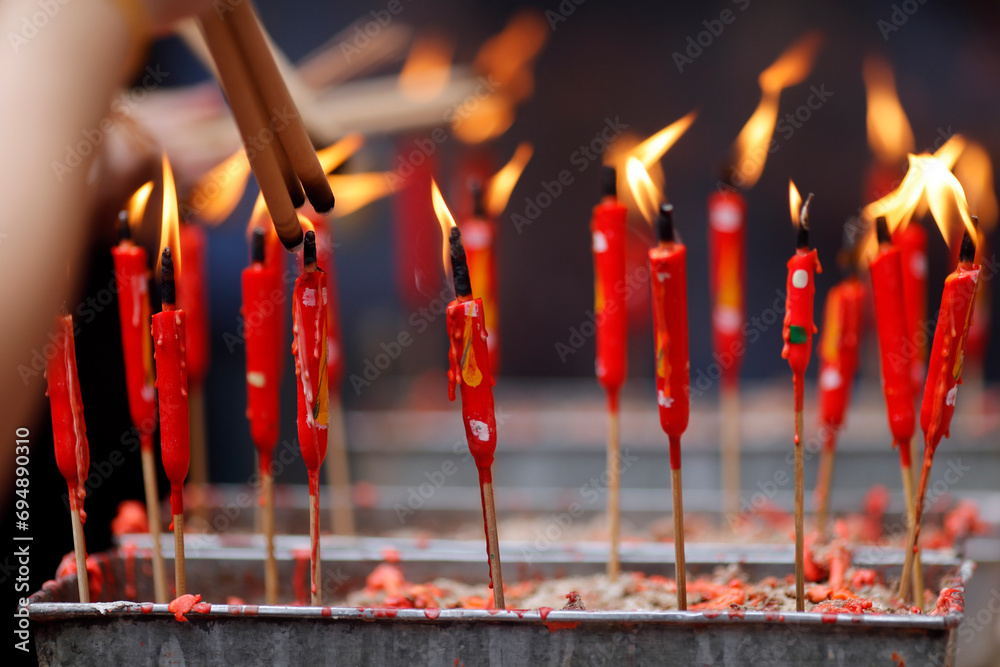 Chinese man burning incense and praying to a prosperous future, Guan Di ...