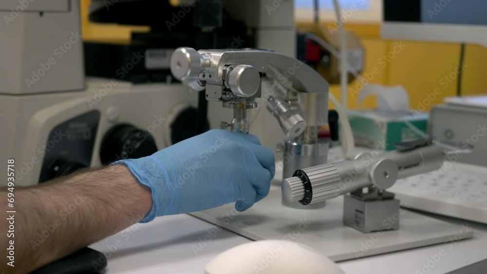 Setting up the modern microscope equipment at the medical laboratory ...