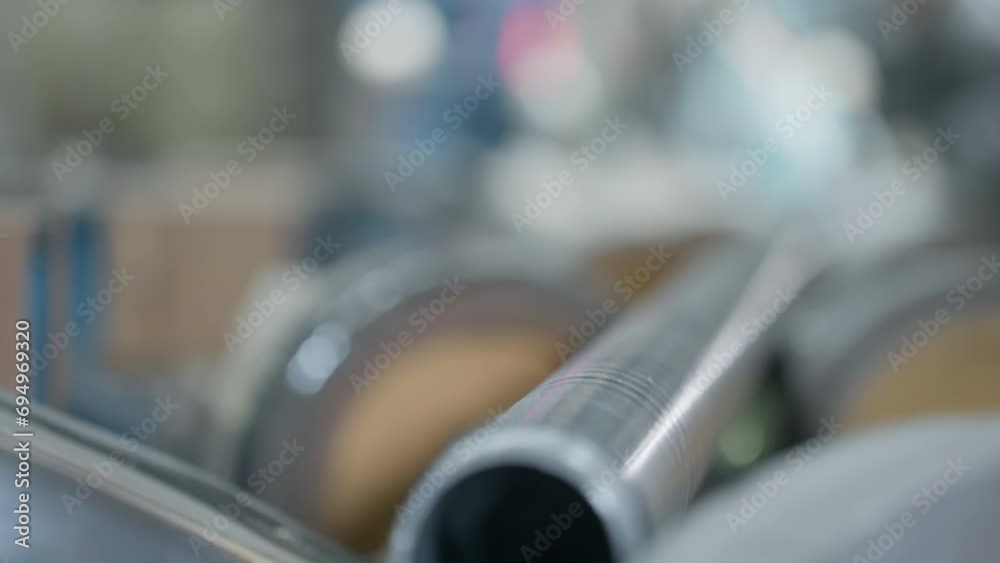 Labourers manufacturing metal tubes inside the factory workshop. Tube ...