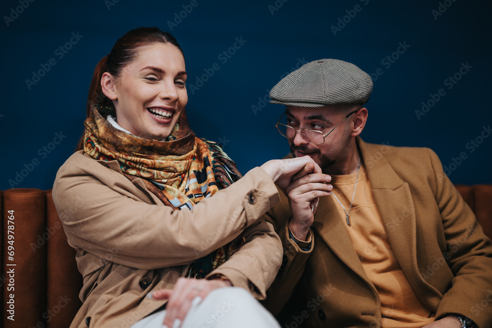 Handsome, male employee kissing his female colleague's hand. He is ...