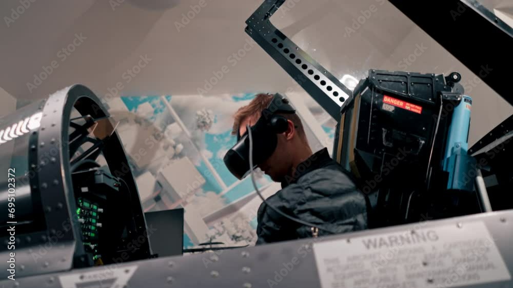 guy sitting in flight simulator of military plane wearing virtual ...