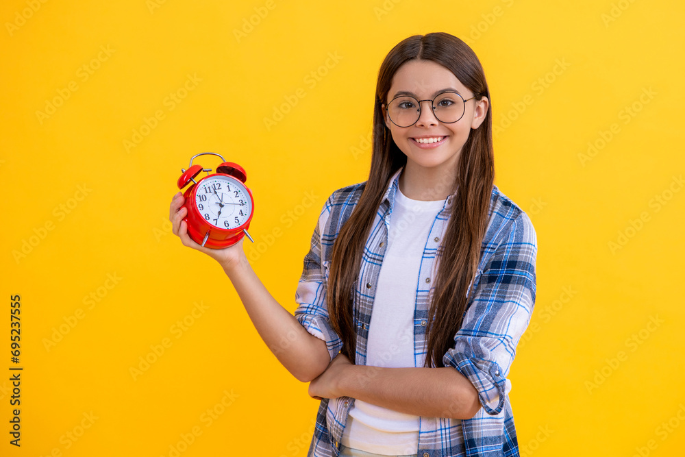 Teen girl hold alarm clock. school time. Teen girl checking the clock ...