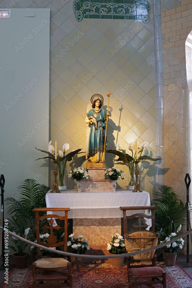 Holy statue shrine figure of St. Raphael, the Archangel holding staff ...