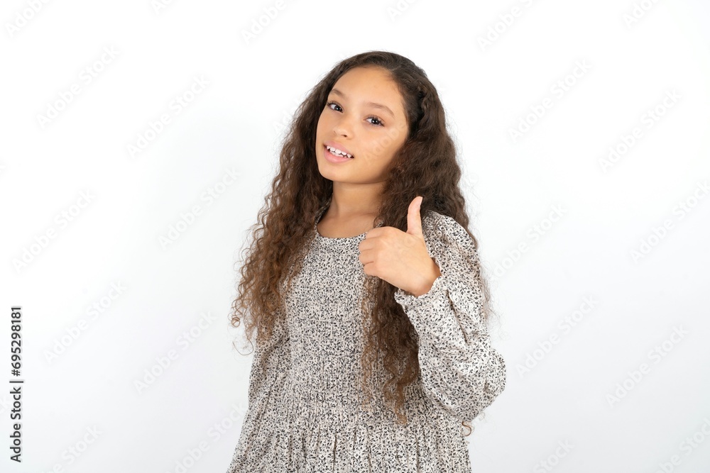 Beautiful teen gil wearing gray dress over white background doing happy ...