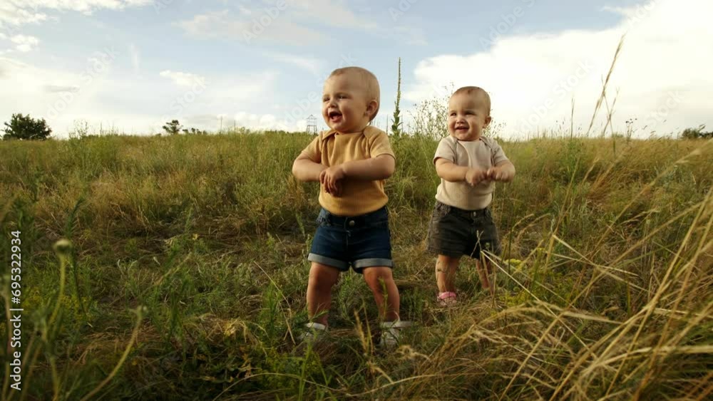 Vidéo Stock Happy children playing in a field outdoors. Children's ...