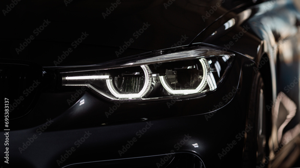 Black modern car headlights - front view. Silhouette of black sports ...