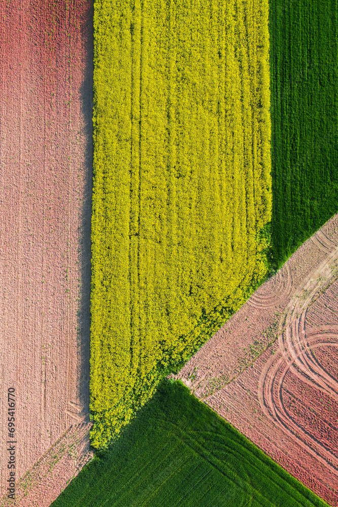 Textured aerial view of farmland showing geometric patterns of plowed ...
