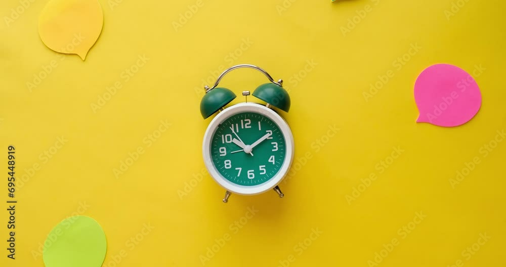 Green classic alarm clock and appearing empty speech bubbles on an ...