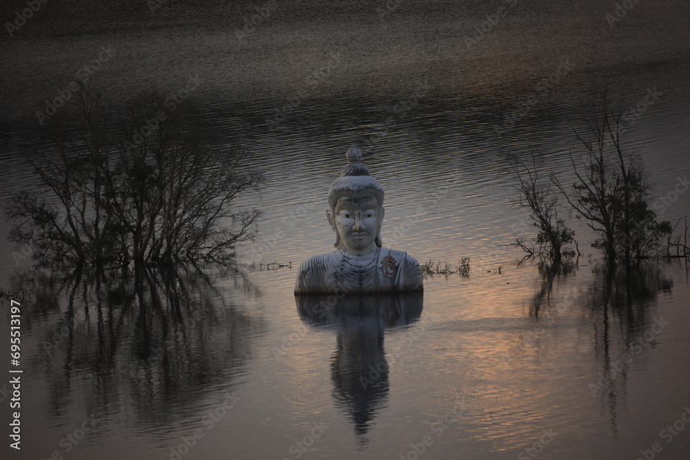 Sinking Buddha statue (Drowning Buddha) and reflection.A large Buddha ...