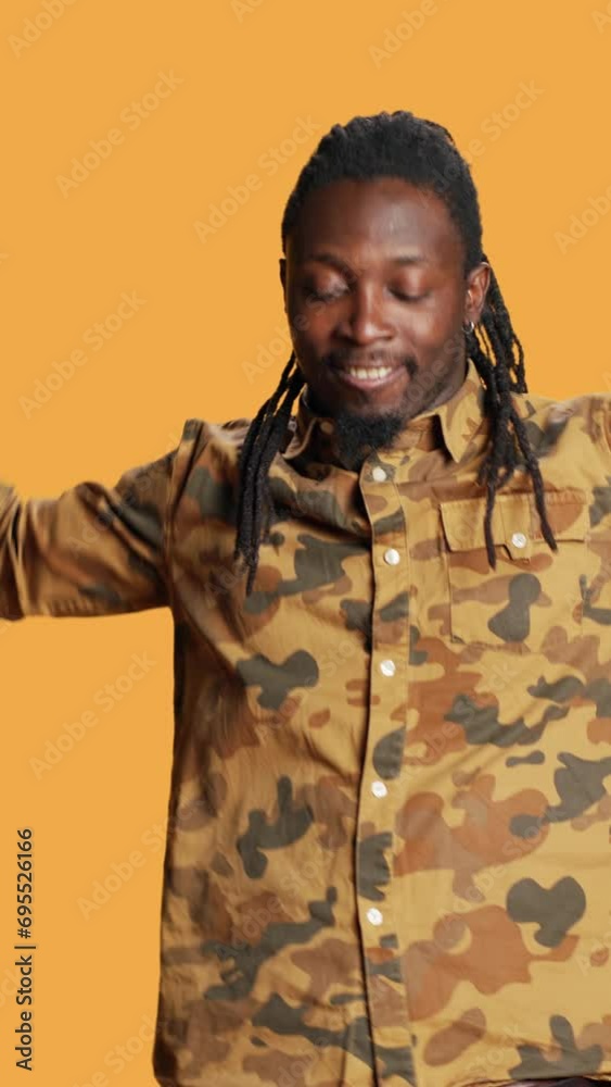 Vertical Video Strong person flexing his muscles on camera and showing ...