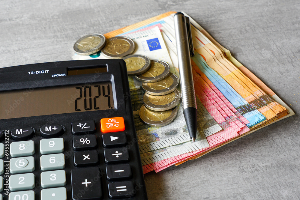 Poster Calculator with number 2024 on display, pen, euro banknotes and ...