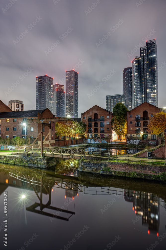 Historic Castlefield in Manchester at night with the modern skyline in ...