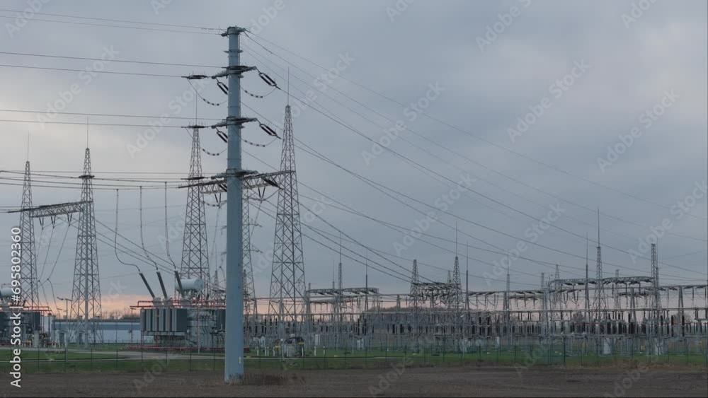 Vídeo do Stock: Sunset hues backdrop a transformer station, recorded by ...