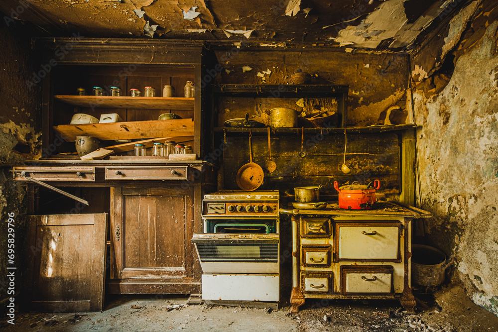 The old rotten mansion with demolished cars. Stock Photo | Adobe Stock