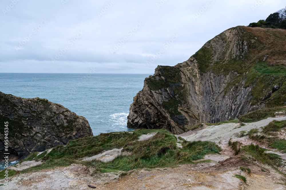 Lulworth Cove cliffs view on a way to Durdle Door. The Jurassic Coast ...